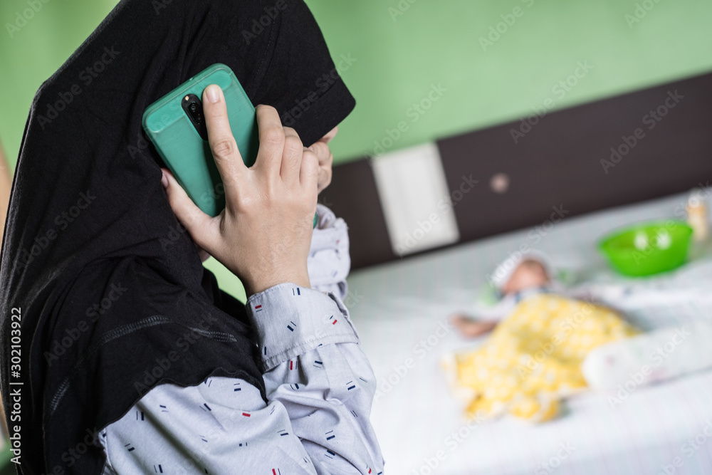 Stress and worried muslim mother wearing hijab call for emergency for ...