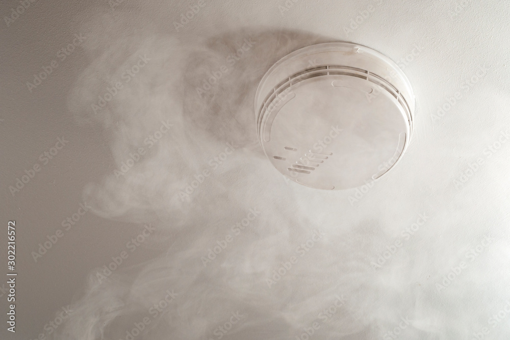 Fire alarm system and home security conceptual idea with smoke rising ...