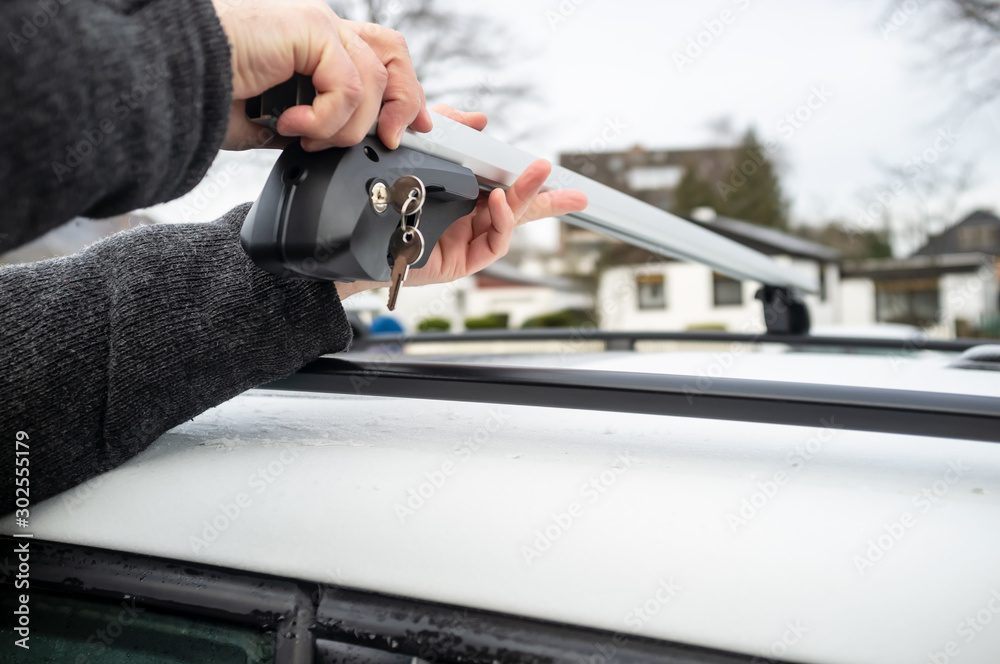 Foto de Stock Man installs attachments with a lock and keys for the ...