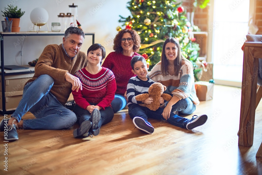 Beautiful family smiling happy and confident. Sitting on the floor and ...