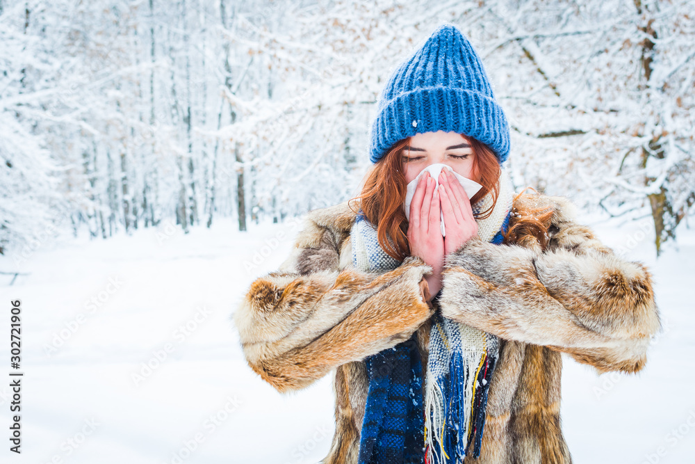 portrait of a young woman in the winter forest. a beautiful girl ...