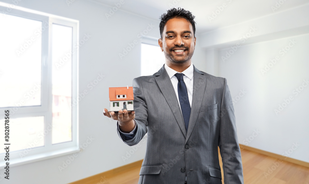 real estate business and people concept - indian man realtor with house ...