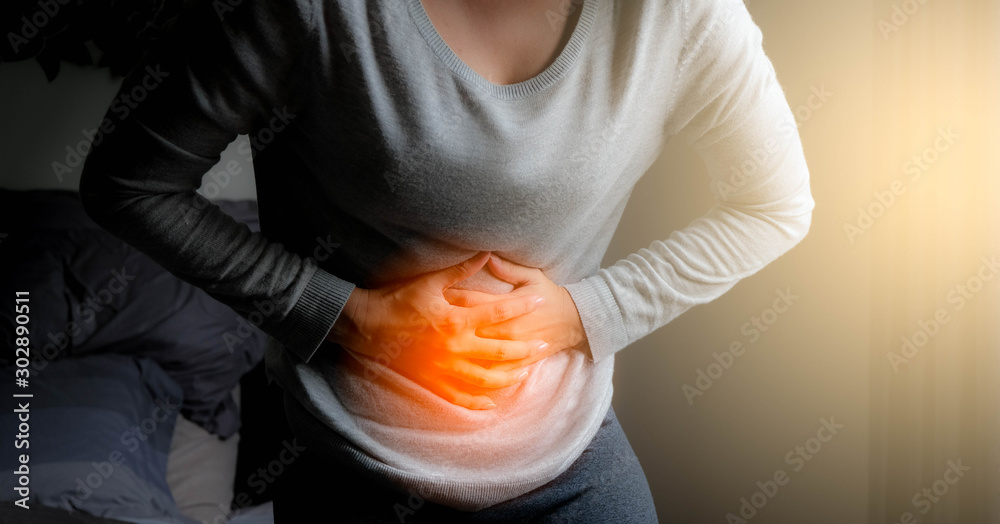 Asian girl stand and hold hand at stomach ache like symptoms specific ...