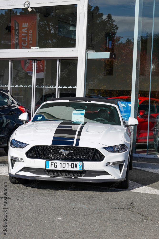 Ford Mustang convertible car in front of automobile motor company ...