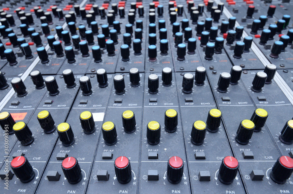 Buttons, levels, switches, speaker volume control on an audio mixer ...