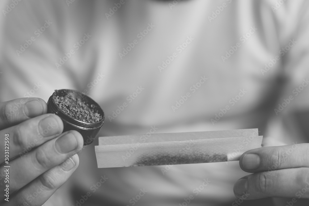 rolling a marijuana weed joint . Man rolling cannabis blunt. Close up ...
