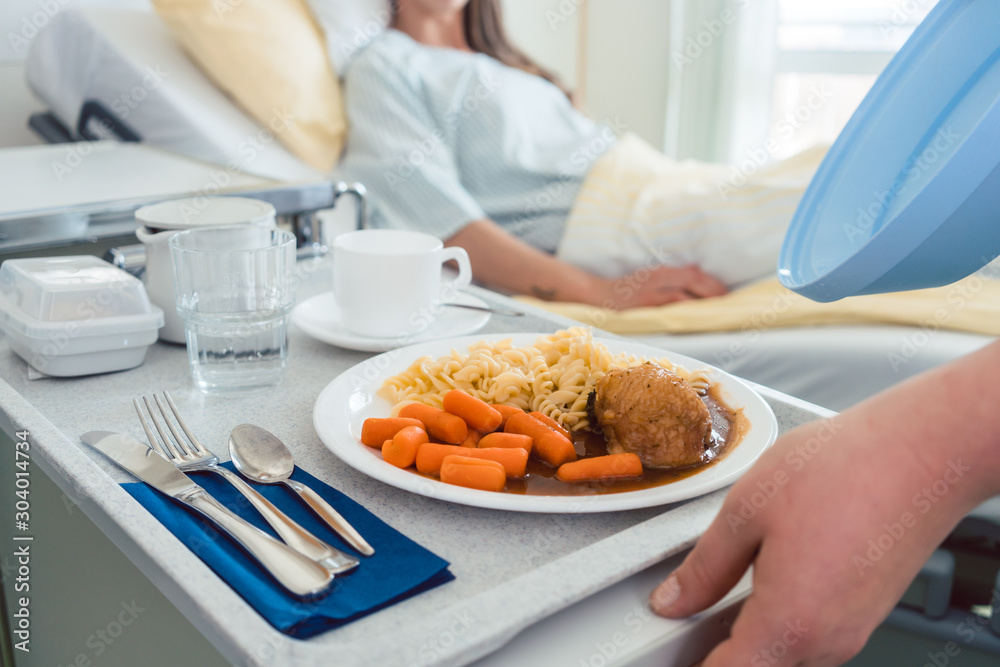 Foto Food delivered to a patient in hospital bed do Stock | Adobe Stock