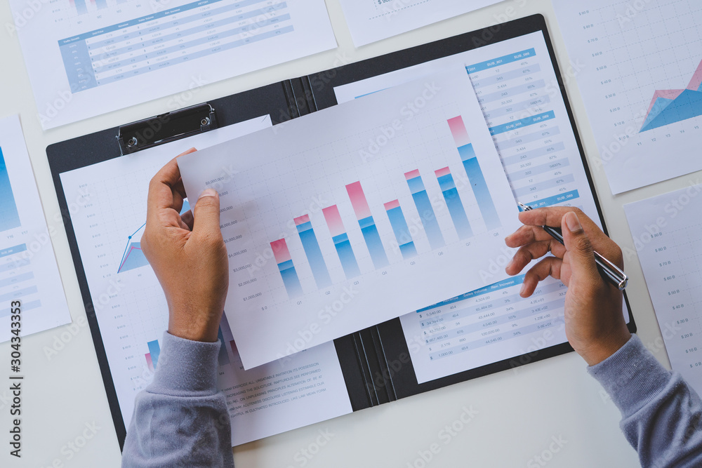 businessman working calculate data document graph chart report ...