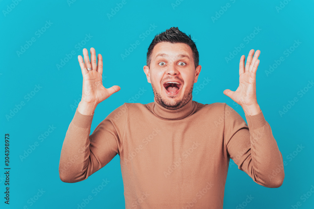 I can't believe this. Amazed handsome man scream holding hands in ...