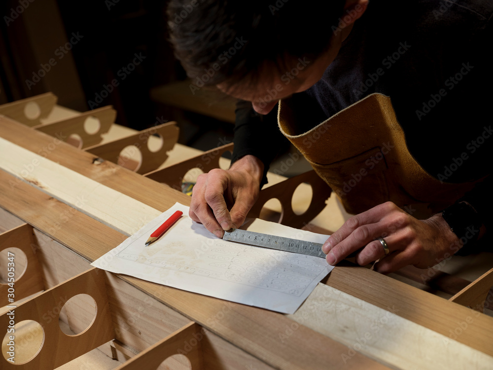 Man using ruler and pencil in design workshop Stock Photo | Adobe Stock