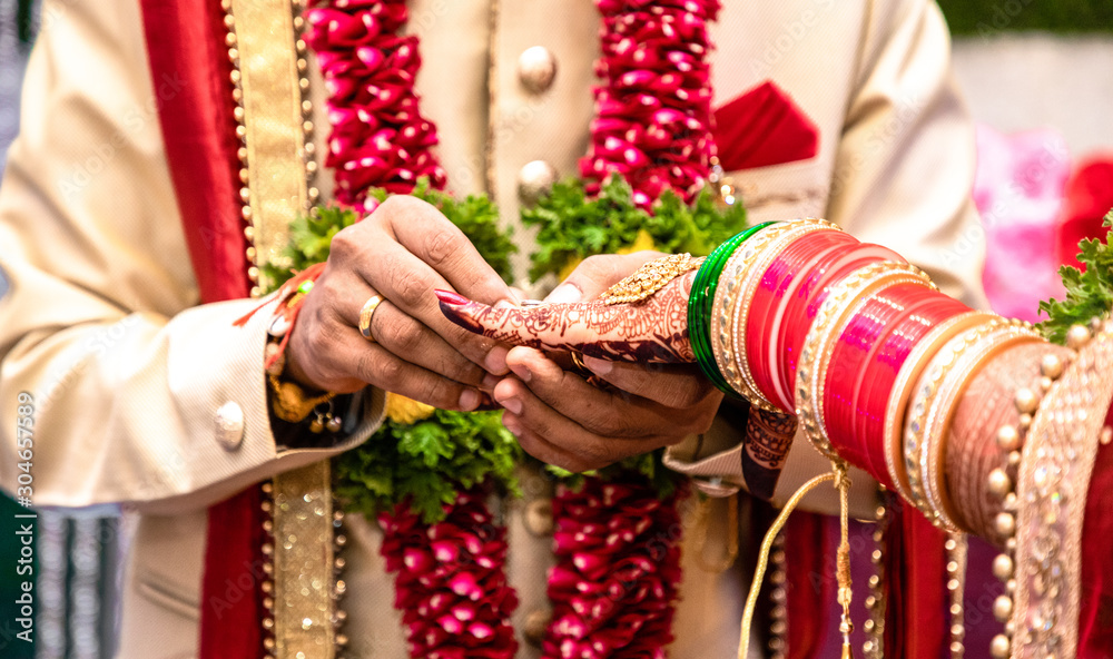Engagement Ring ceremony- Indian Hindu male putting ring on bride's ...