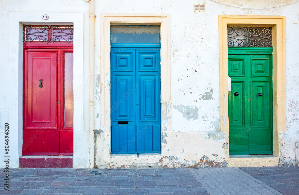 Three typical traditional maltese doors in Marsaxlokk village. Red ...