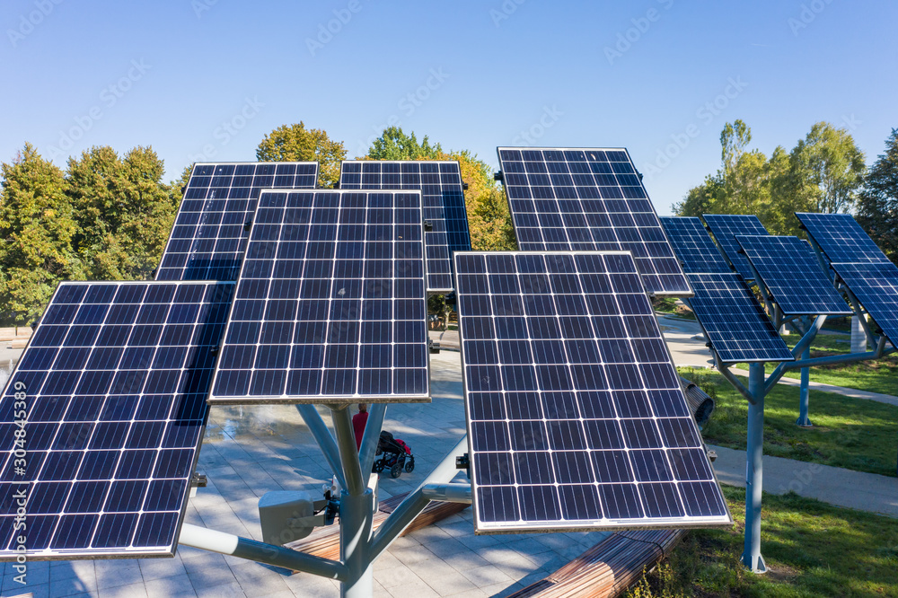 Solar panels are located in the city park of Warsaw, Poland. Drone ...