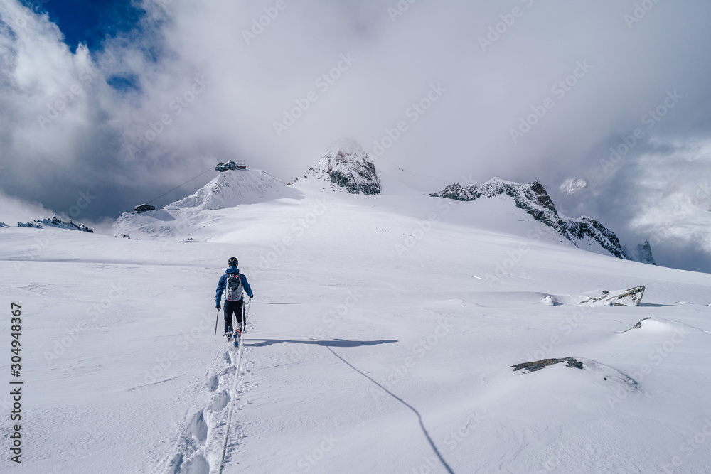 Climbers walking on a glacier using rope and ice axe. Alpinist in high ...
