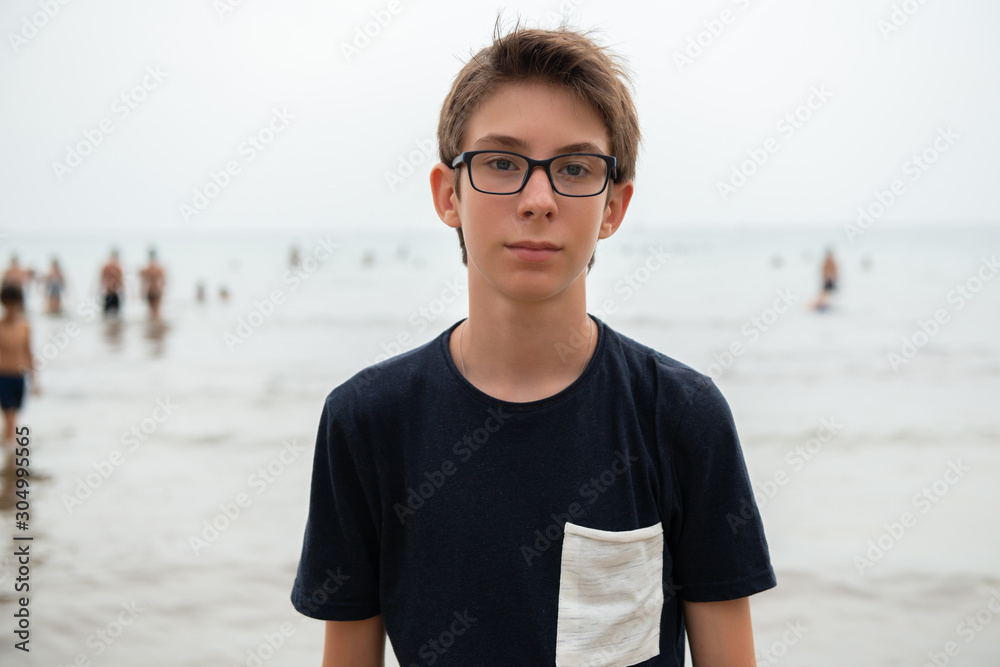 Handsome young boy at beach in Alicante. Beautiful calm smiling teen ...
