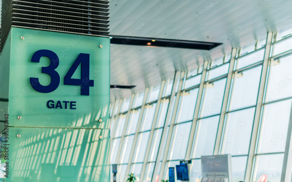 Interior of airport terminal with the sign depicting gate number Stock ...