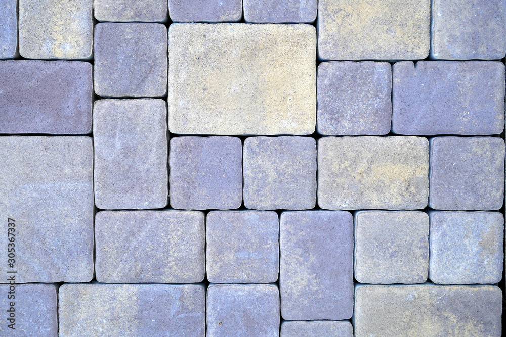 colored paving slabs by mosaic, closeup. Road paving construction ...
