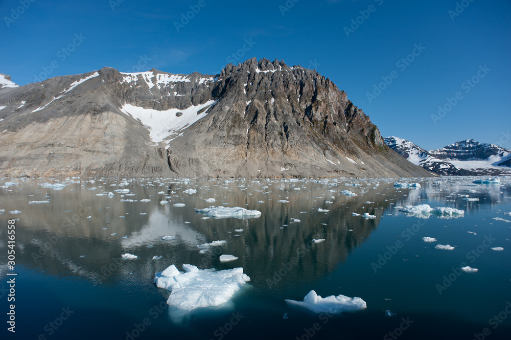Stock-Foto „Arctic scene of melting ice and bare rock shows impact of ...