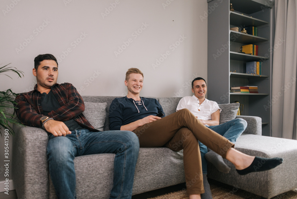 People Sitting On Couch Watching Tv