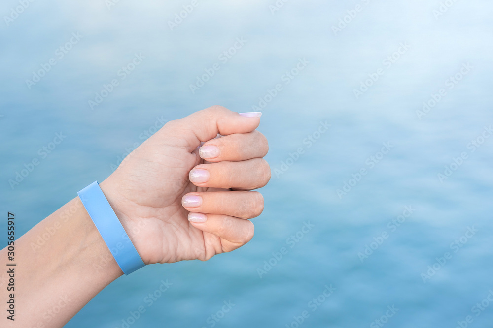 Closeup view of beautiful white female hand wearing rubber wristband of ...