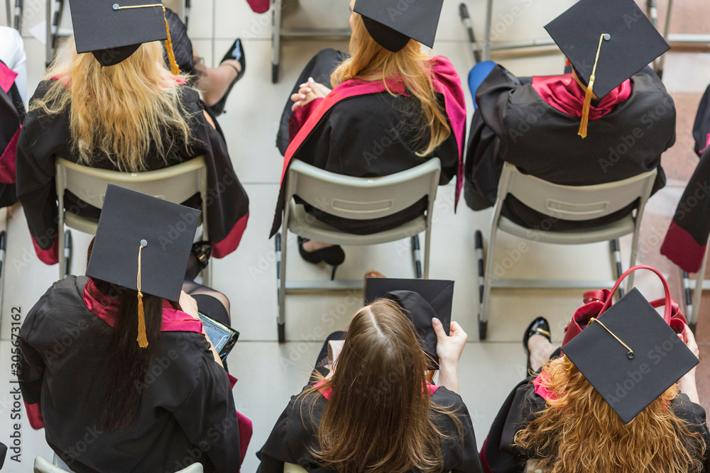 students together in a hall in festive and formal wear. many students ...