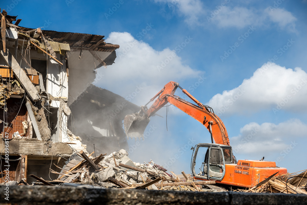 Big bulldozer earth mover or digger on tracks standing on pile of ruin ...