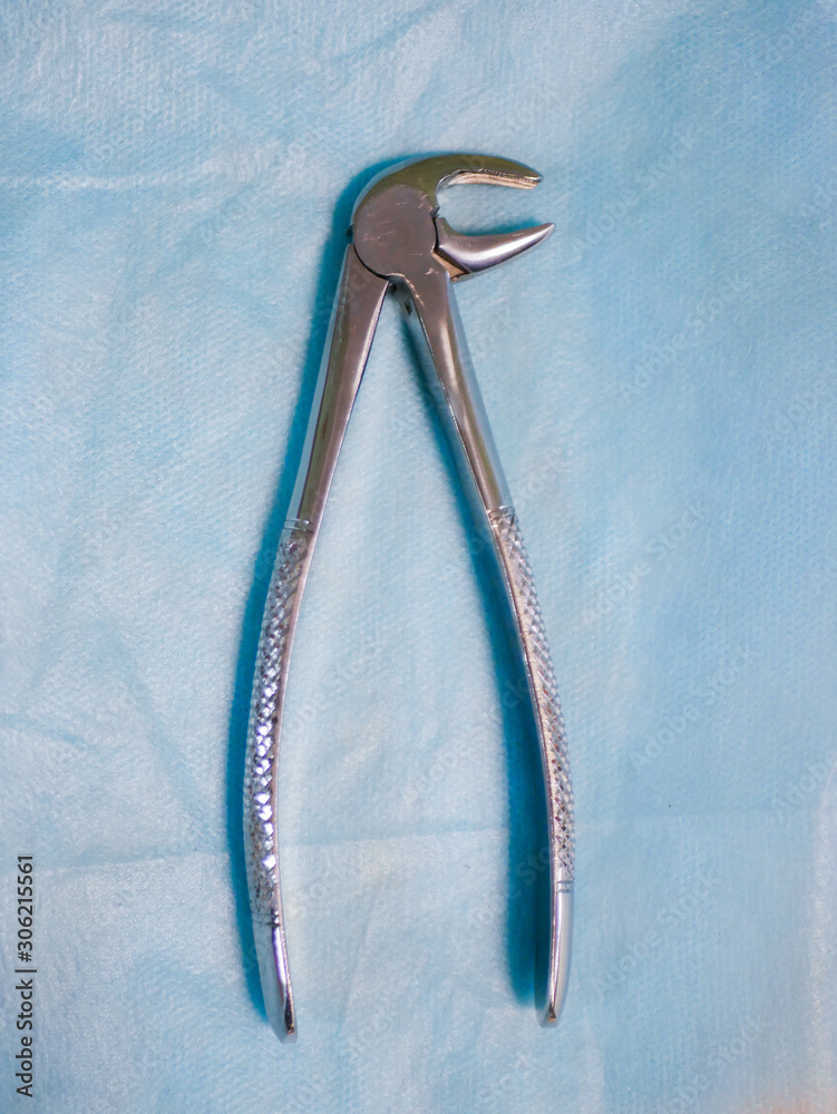 Dental tool for removing teeth. close top view. removal of a tooth ...