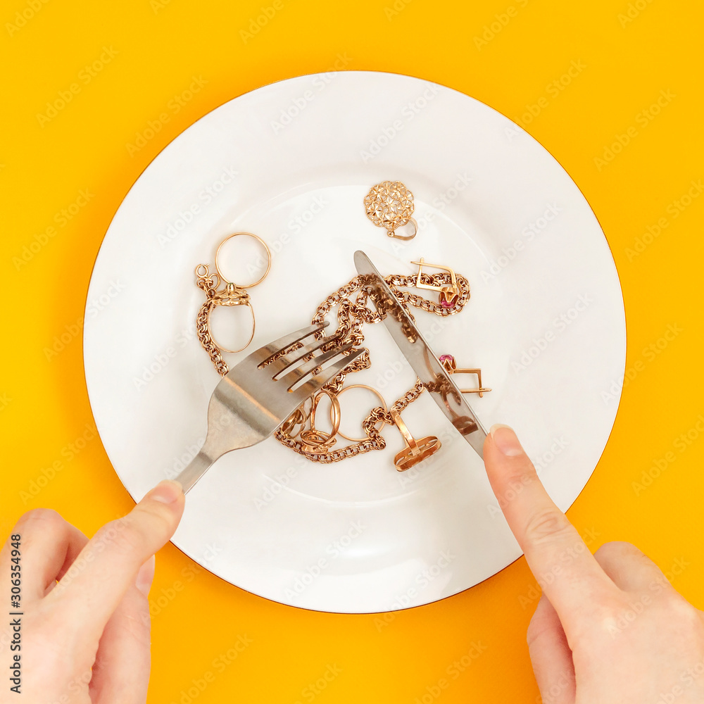 Foto de Stock Girl eating gold jewelry from plate. Eating disorder ...