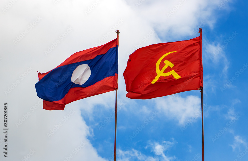 The Lao National Flag with the red flag with communist symbols of a ...