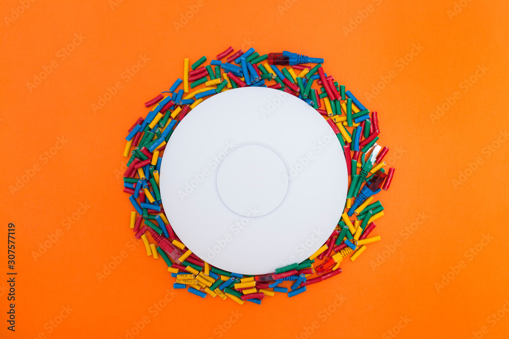 Access point with bright cables connected on it on the orange ...