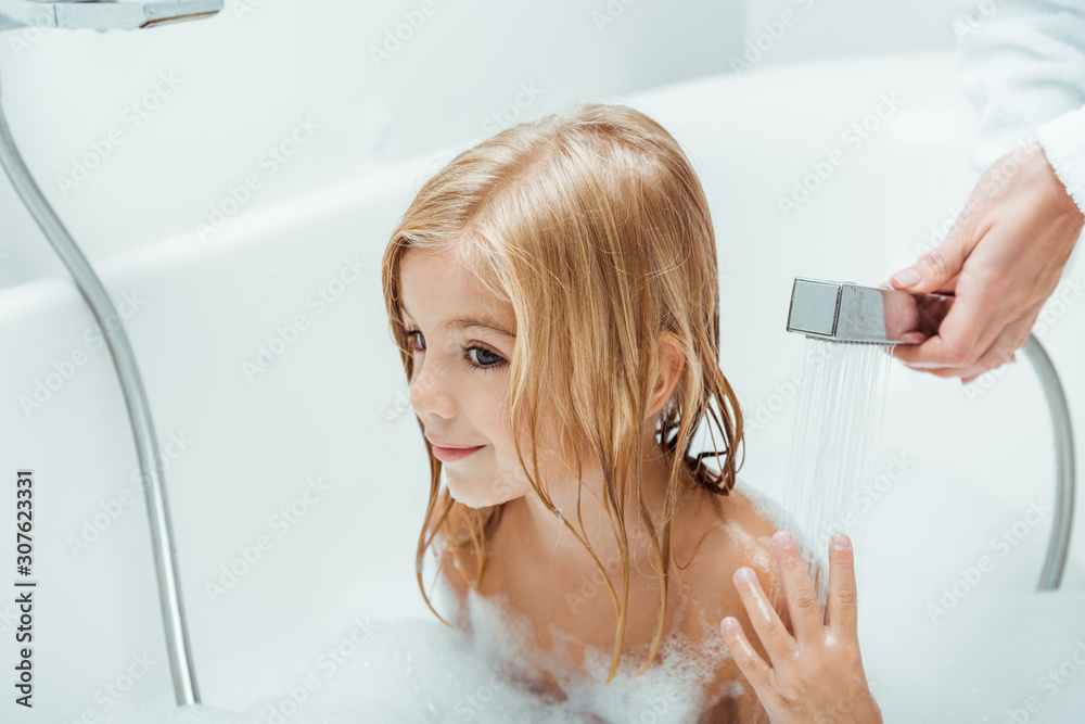 cute and naked kid taking bath near mother in bathroom Stock Photo ...