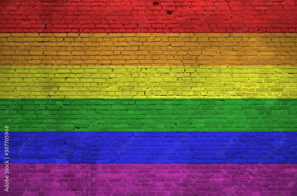 LGBT community flag depicted in paint colors on old brick wall ...