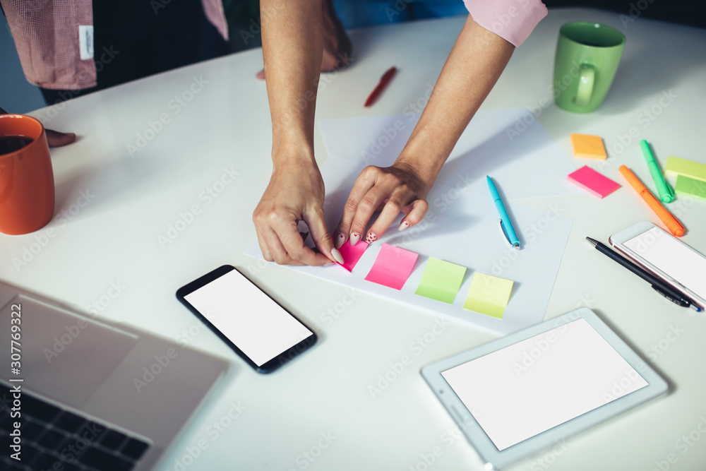 Cropped image of female hands sticking memo note template during ...