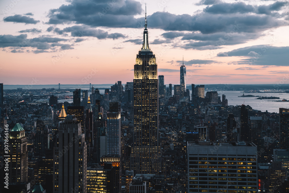 Aerial view of glowing skyscraper with bright buildings around located ...