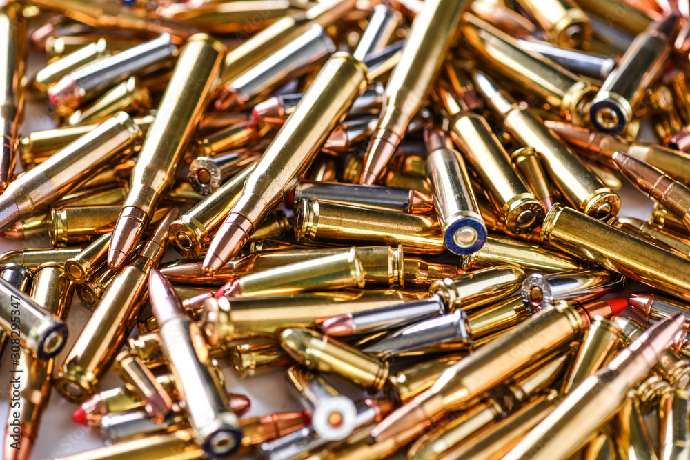 Pile of fire bullets or ammunition on dark stone table. Hand guns ...