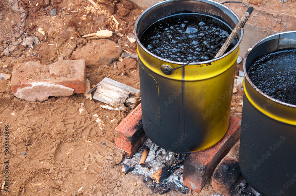 Banks with bitumen on the construction site on fire. Stock Photo ...