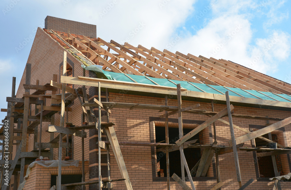 Unfinished brick house rooftop roofing construction attic trusses ...