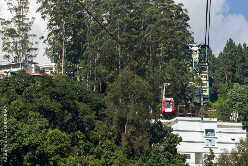Big cabin of the cable car .The red cabin of the ropeway with tourists ...