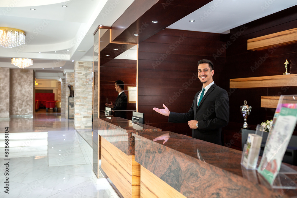Receptionist welcoming guests to a hotel Stock Photo | Adobe Stock