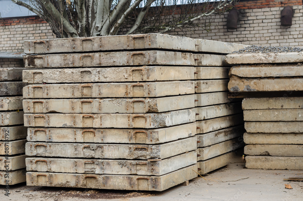 A stack of reinforced concrete slabs outdoors. Open-air finished goods ...