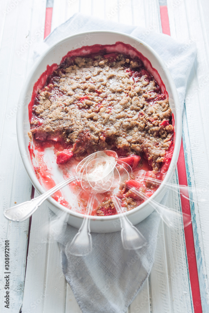 Crunchy strawberries crumble, top view, halfserved, multiple ...