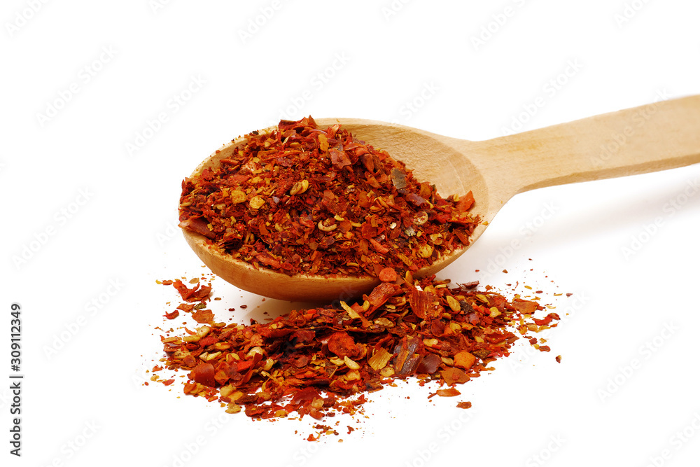 ground dried chili pepper flakes in wooden spoon isolated on white ...