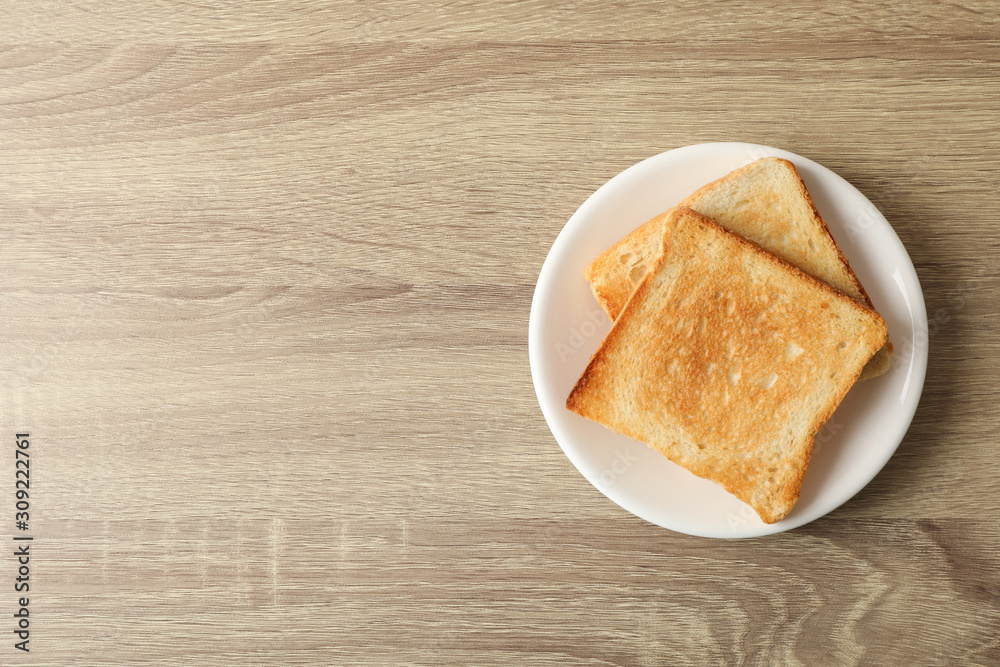 Plate with toasts on wooden background, top view Stock Photo | Adobe Stock