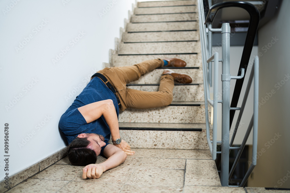 Unconscious Man Lying On Staircase Stock Photo | Adobe Stock