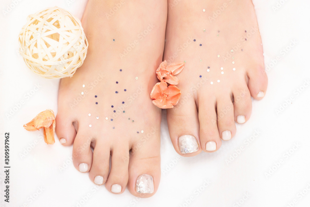 Female legs on a white background. Nails get a fresh and neat look ...