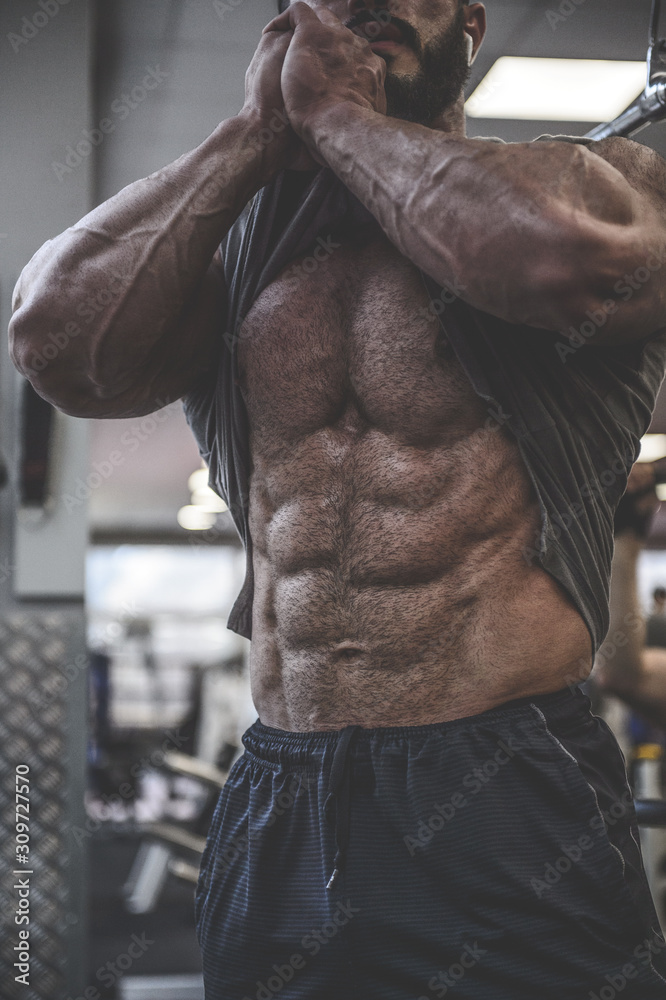 strong young muscular bearded athlete man showing his powerful physique ...