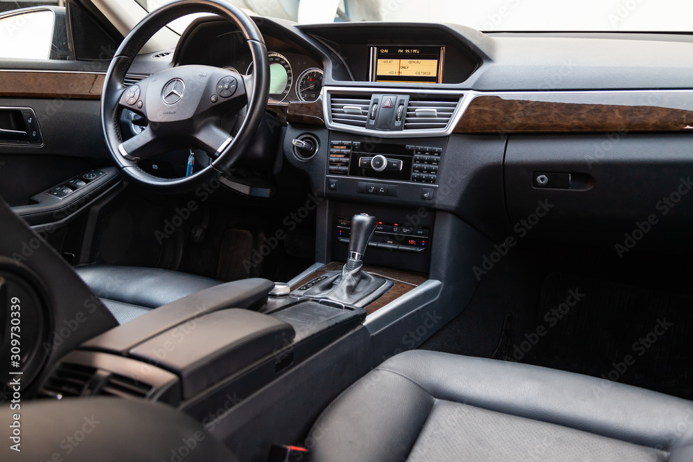 View to the interior of Mercedes E-Class W212 with dashboard, clock ...