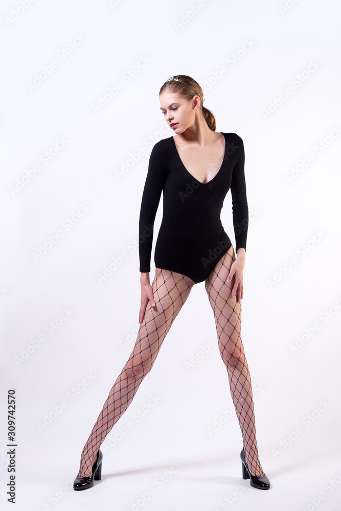 Portrait of a young beauty blondy woman posing in black body, pantyhose ...