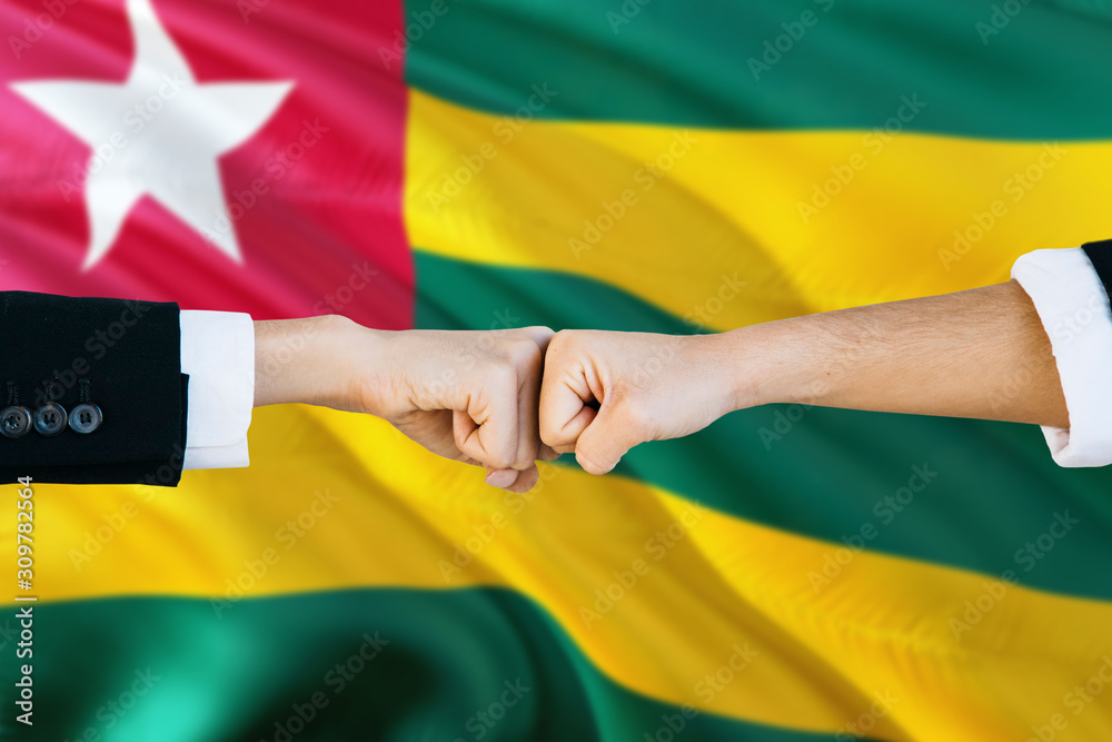 Togo agreement concept. Man and woman fist bumping on national flag to ...