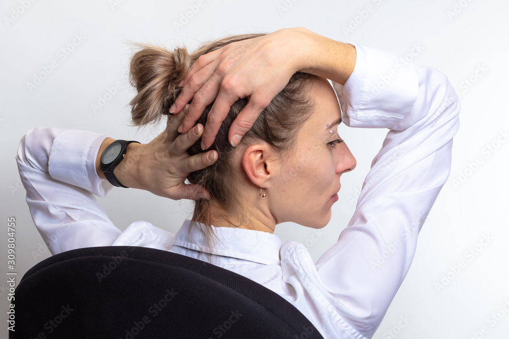 The woman in the office chair turned her back. Corrects the hairstyle ...